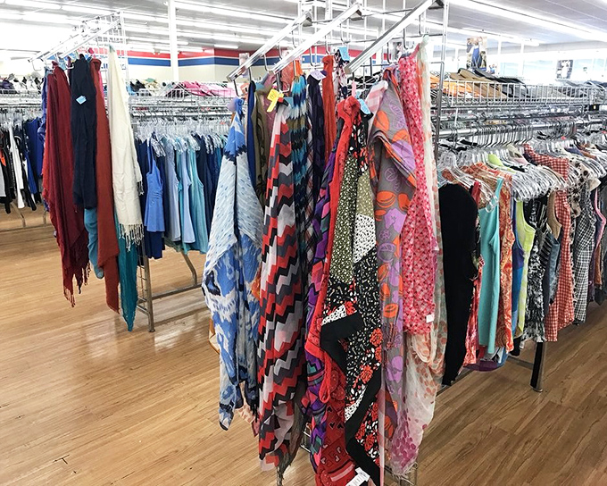 A rainbow of fabrics tells a thousand stories. Each scarf and blouse once belonged somewhere else—now they're waiting for your next chapter.