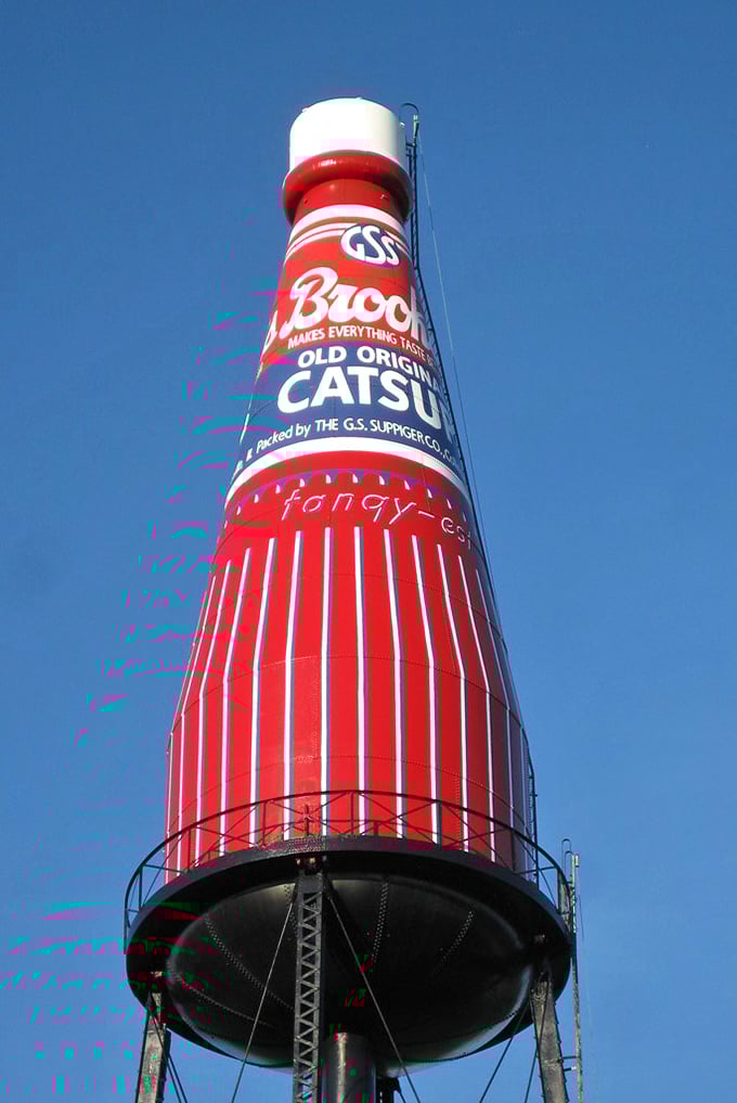Looking up at this towering testament to tomato technology, you can almost taste the tangy nostalgia of backyard barbecues past. 