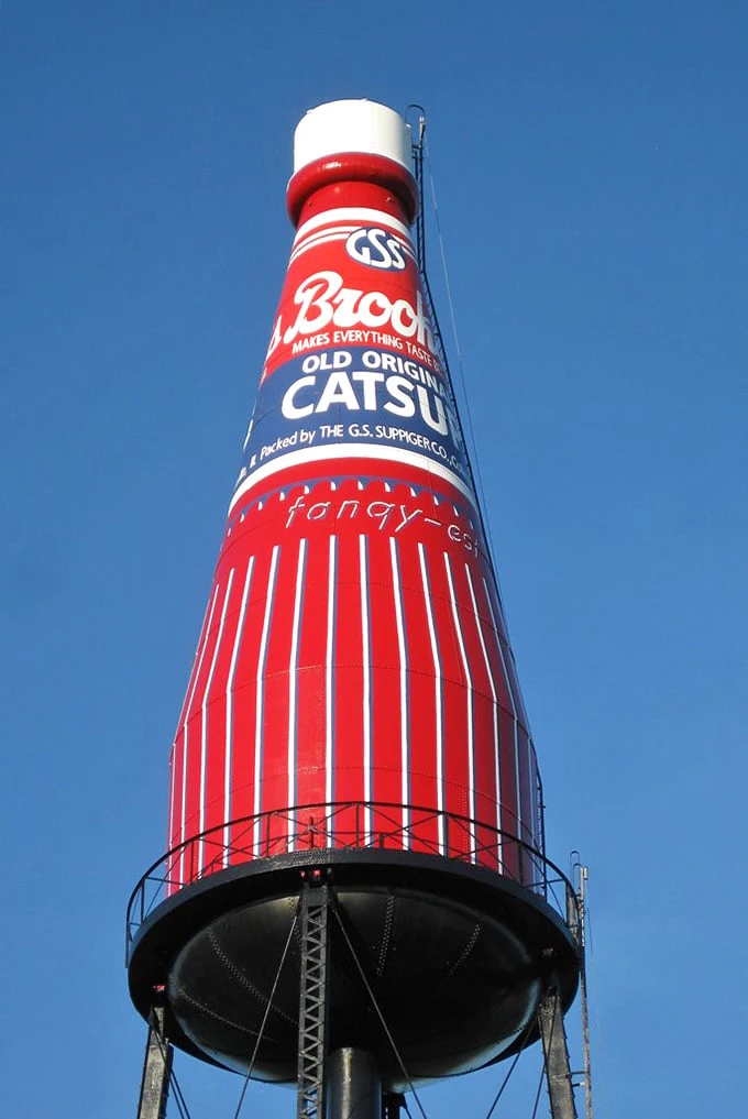 Looking up at this towering testament to tomato technology, you can almost taste the tangy nostalgia of backyard barbecues past.