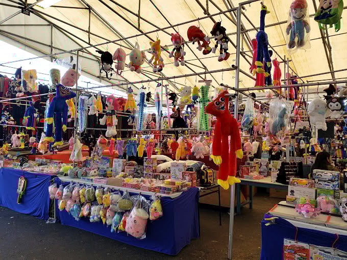 Plush paradise! These dangling stuffed companions are just waiting to be adopted and taken home—childhood nostalgia suspended from the ceiling.