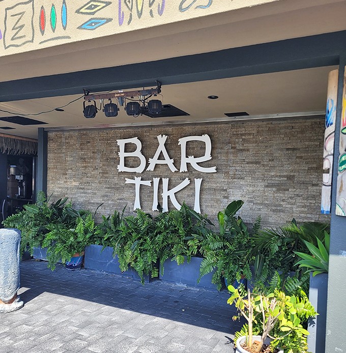 Bar Tiki's bold brick-and-fern entrance isn't just a sign—it's an invitation to escape the ordinary into a tropical state of mind.