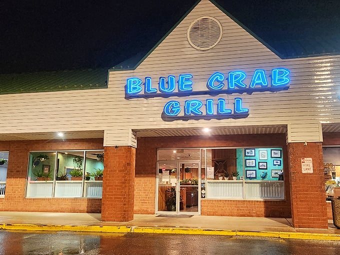 Blue Crab Grill's neon sign glows like a beacon for seafood lovers – proof that strip malls sometimes hide the most delicious secrets.
