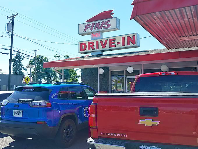Fins Drive-In's vintage sign promises what every road trip needs—a burger joint where Elvis would feel right at home.