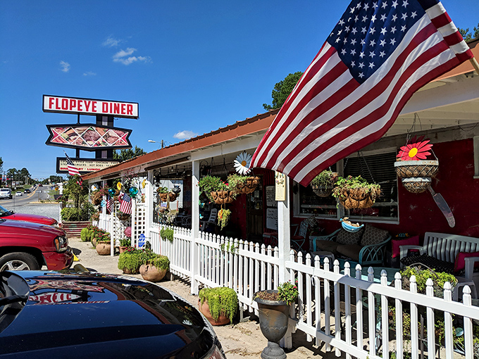 Flopeye Diner waves the stars and stripes proudly alongside hanging plants and a white picket fence – Norman Rockwell would approve!