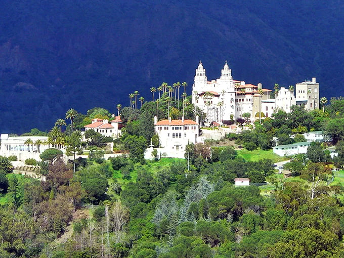Hearst Castle: A white Mediterranean palace crowns the hilltop like a dream, surrounded by palm trees instead of drawbridges—California's own Xanadu.