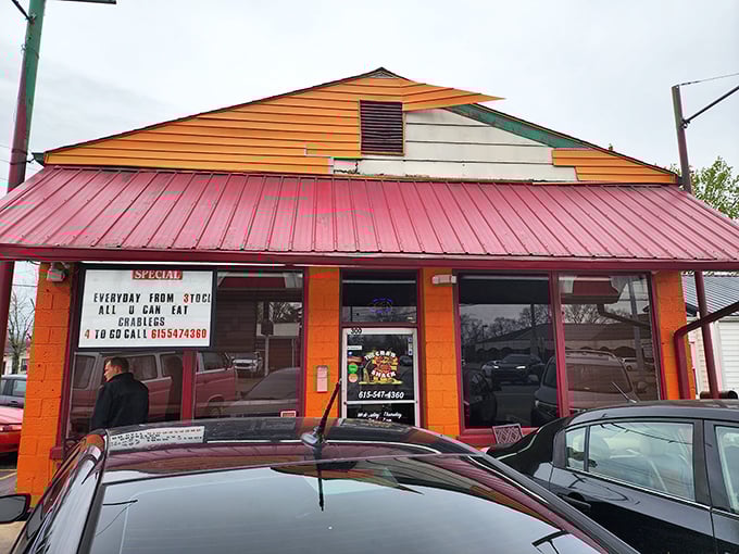The Crab Shack's vibrant orange exterior is like a sunset warning: prepare for a seafood storm of deliciousness!