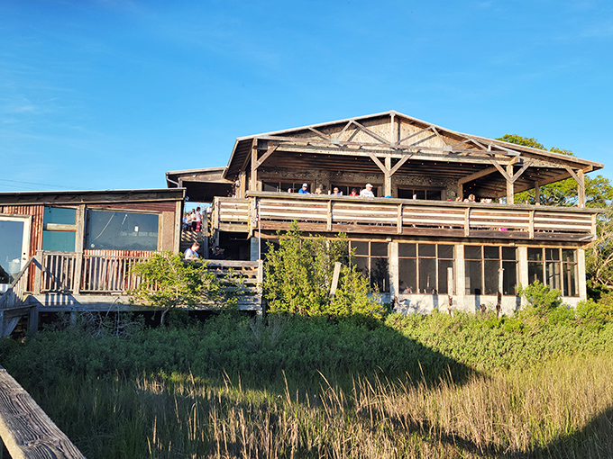 That deck isn't just a place to eat—it's front-row seating to nature's dinner theater of marsh views and spectacular sunsets.