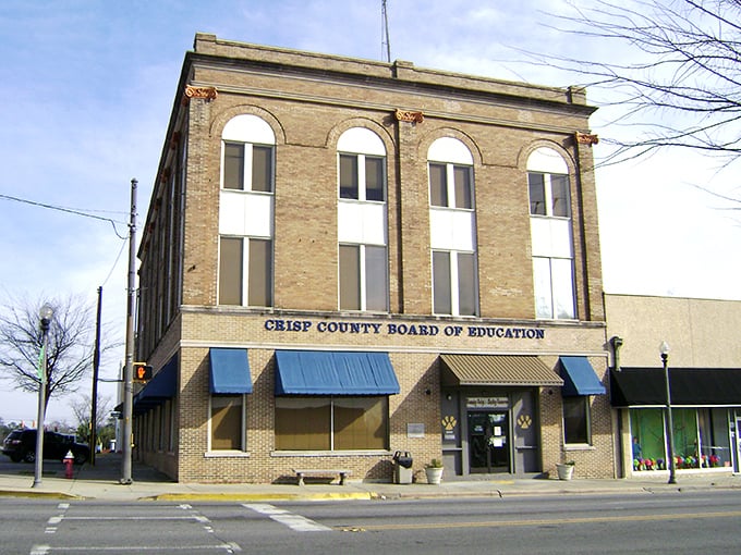 The Crisp County Board of Education building anchors downtown Cordele, where your Social Security check stretches like summer daylight.