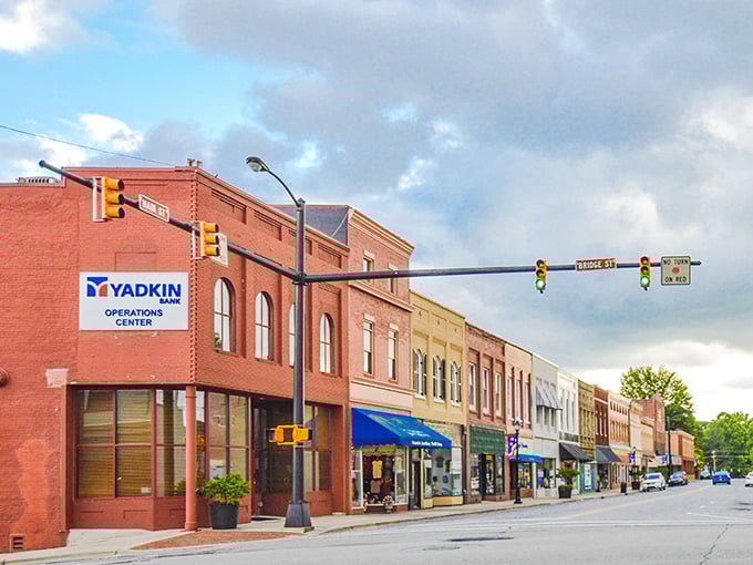 Main Street Elkin proves small towns offer big value. Your Social Security check buys more beneath those leafy green trees!