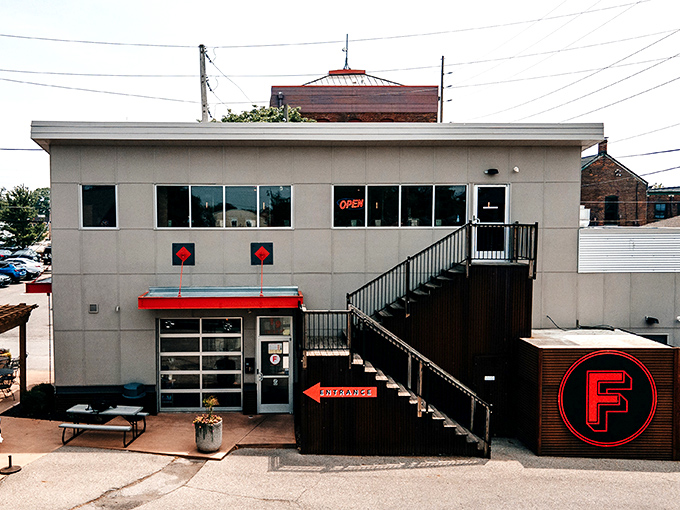 That staircase isn't just an entrance – it's a red-lettered invitation to ascend into Detroit-style pizza heaven.