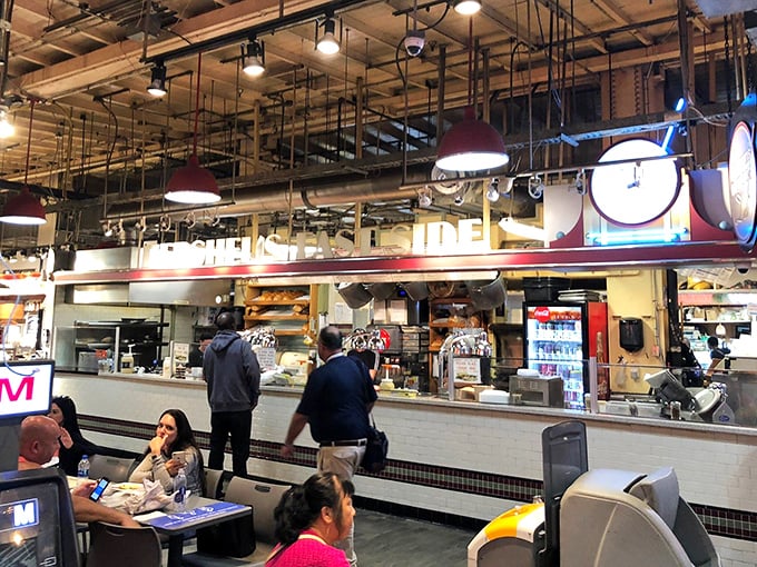 The organized chaos of Reading Terminal Market frames Hershel's perfectly—a deli counter where sandwich artistry happens in plain sight.
