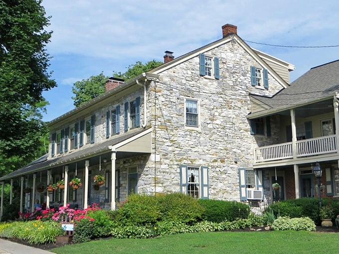 Hanging flower baskets and a welcoming porch – this stone farmhouse has been perfecting "come on in" vibes for centuries.