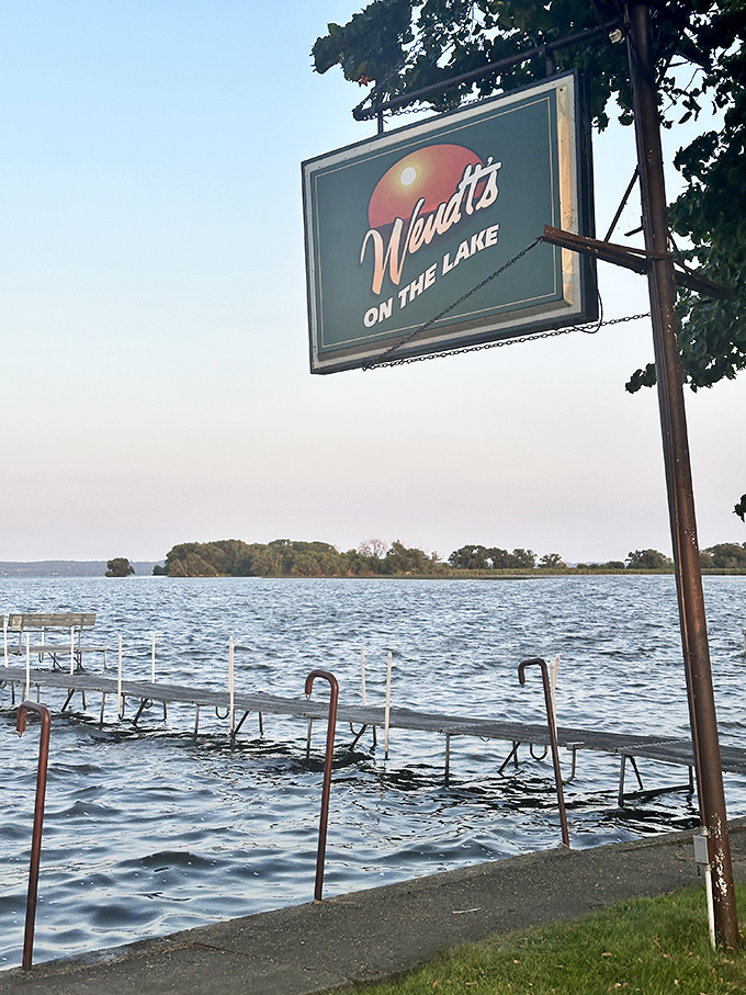 Wendt's on the Lake sign stands proudly by the water—like a lighthouse guiding hungry sailors to fried perch paradise.