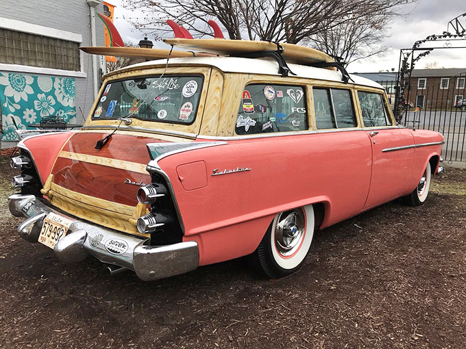 This salmon-pink 1955 Dodge Coronet Suburban isn't just transportation—it's a California dream with surfboards on top and nostalgia under the hood.