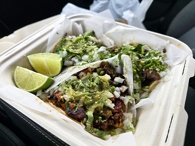 These street-style tacos aren't just food—they're edible art, with each component precisely arranged and those lime wedges standing by for their crucial supporting role.