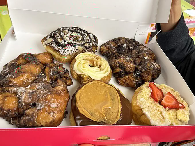 A box of pure happiness – each donut telling its own delicious story of glaze, chocolate, and possibility.