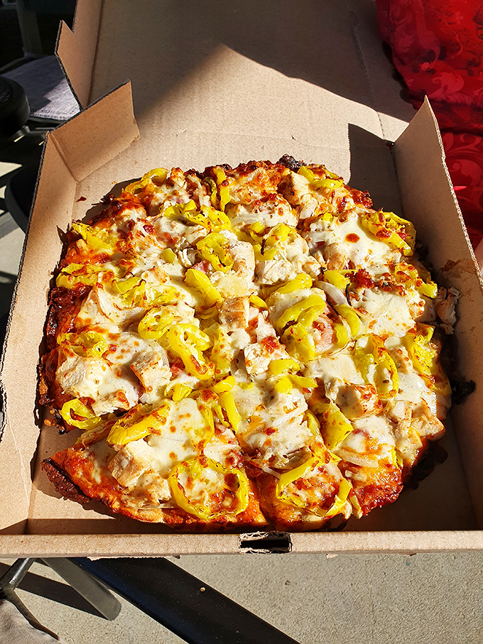 This BBQ Chicken Pizza isn't just food – it's edible artwork with its golden cheese, tender chicken chunks, and those bright banana peppers adding the perfect zing.