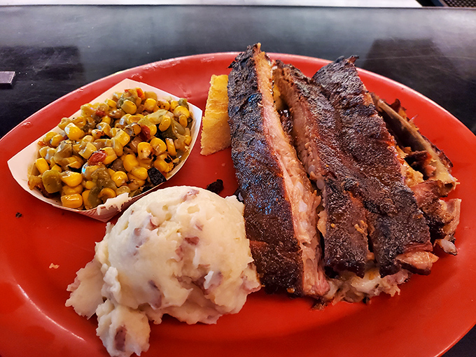 Behold barbecue perfection: ribs with that coveted smoke ring, served with mashed potatoes and corn that aren't mere afterthoughts but worthy sidekicks.
