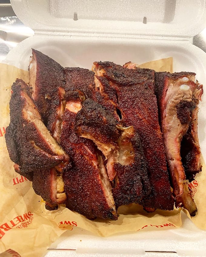 These ribs don't just fall off the bone—they practically leap into your mouth. That bark is the barbecue equivalent of a perfect vinyl record crackle.