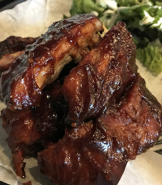 These aren't just ribs – they're glistening monuments to patience, smoke, and the art of perfect BBQ.