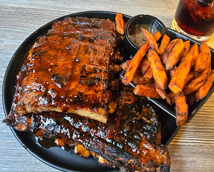 Fall-off-the-bone ribs that make you question every relationship you've ever had. Those sweet potato fries aren't sidekicks—they're co-stars in this delicious drama.