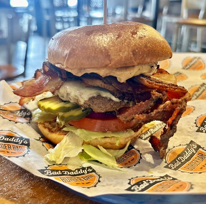 Behold the architectural marvel that is a Bad Daddy's burger—where bacon, beef, and veggies unite in a towering tribute to American ingenuity.