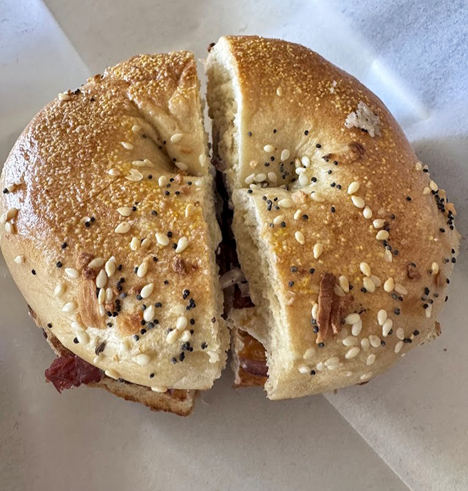 This isn't just a bagel sandwich; it's edible architecture – a perfect ratio of chewy bread to savory filling that makes fast food chains weep with inadequacy.