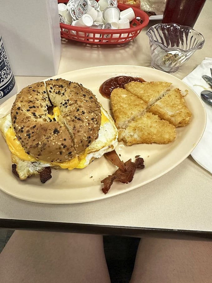 This breakfast sandwich on a seeded bagel isn't trying to impress Instagram—it's too busy preparing to impress your taste buds.