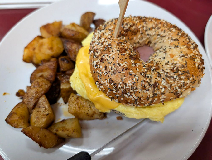 The everything bagel doesn't just have everything on it—it has everything going for it. Golden home fries playing the perfect supporting role.