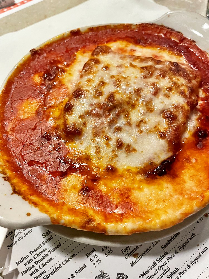 Behold, the star attraction! Luigi's lasagna arrives bubbling hot, with cheese still sizzling from the oven's embrace – a stratified wonder of pasta, sauce, and dairy devotion.