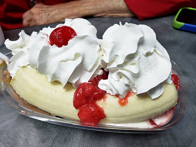 Behold the banana split in its natural glory—a split banana cradling ice cream, crowned with a mountain of whipped cream that defies gravity.