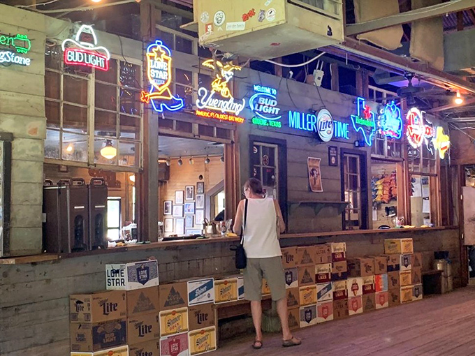 Beer signs illuminate the bar like a honky-tonk Christmas tree. In Texas terms, this is what "interior decorating" looks like when it's done right.