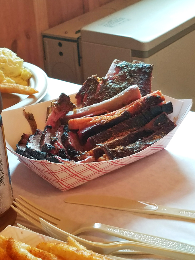 These ribs aren't just smoked, they're transformed—each glistening, bark-crusted piece tells a story of patience, fire, and time-honored technique.