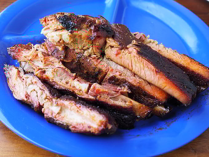 Behold the holy grail of smoked meats—brisket with that perfect pink smoke ring. Each slice is a testament to patience, fire, and time.