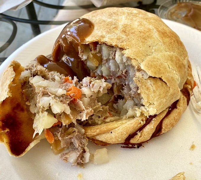 Behold the glory of a proper pasty with gravy – that golden-brown crust giving way to a steaming interior of beef and vegetables. Pure Upper Peninsula comfort on a plate.