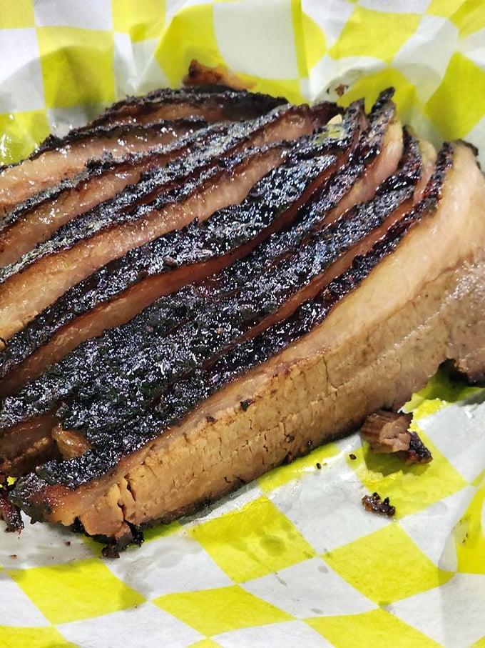 Behold the brisket in all its glory—that bark, that smoke ring, that perfect slice that practically whispers "I've been waiting for you."