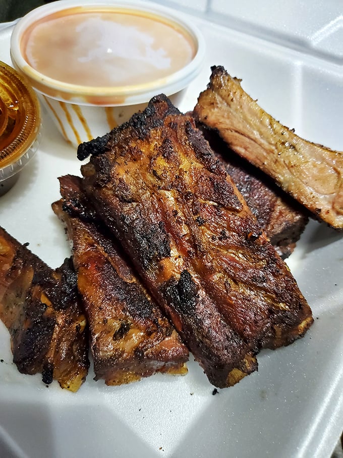 These beef ribs aren't just smoked, they're transformed – sporting a bark so perfect it belongs in a barbecue museum alongside a cup of sauce for dipping.