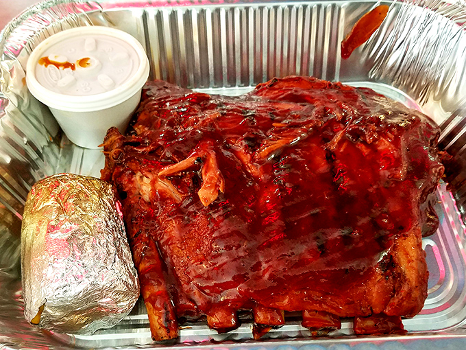 Behold the star attraction: beef ribs so magnificent they'd make Fred Flintstone jealous. That smoke ring isn't just color—it's a flavor halo.