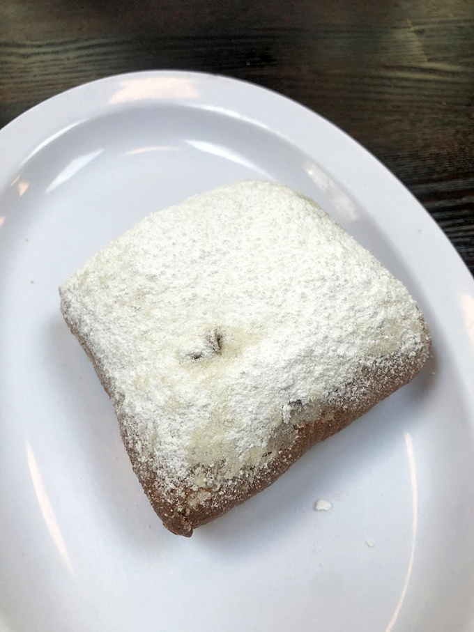 Powdered sugar snowstorm alert! This beignet doesn't just satisfy a craving – it creates a lifelong obsession that no therapist can cure.