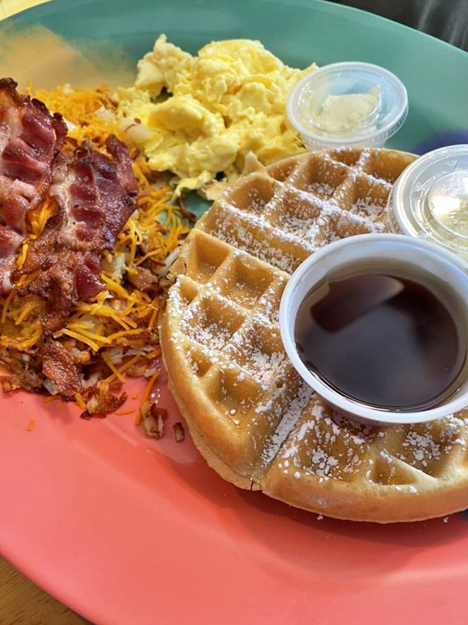 Golden Belgian waffle perfection meets crispy bacon and fluffy eggs—the breakfast trinity that makes getting out of bed worthwhile.