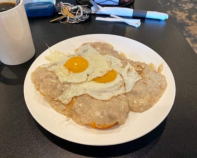 Biscuits smothered in creamy sausage gravy, topped with sunny-side-up eggs—this is what breakfast dreams are made of, folks.