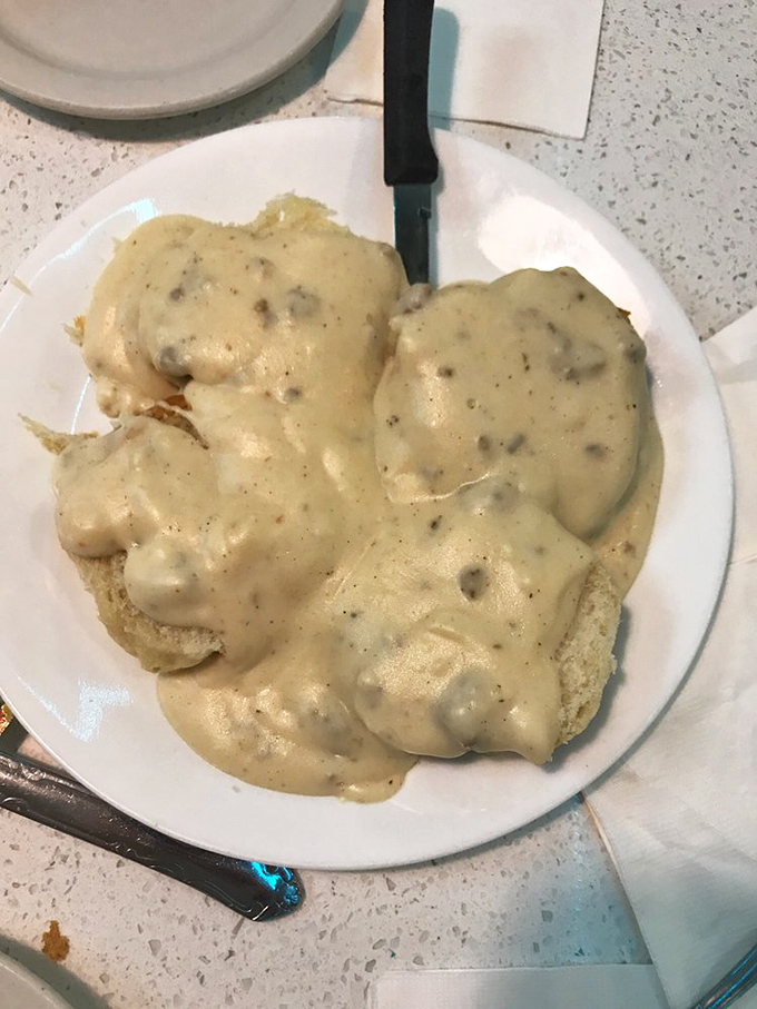 Behold the holy grail of diner cuisine: biscuits smothered in a peppery sausage gravy that would make your cardiologist wince and your soul sing.