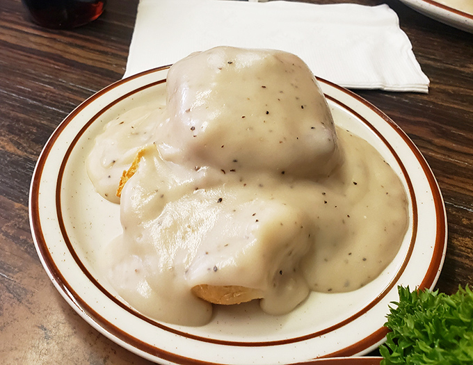 These biscuits and gravy aren't just breakfast—they're a spiritual experience. That pepper-flecked gravy blankets the biscuit like a warm hug.