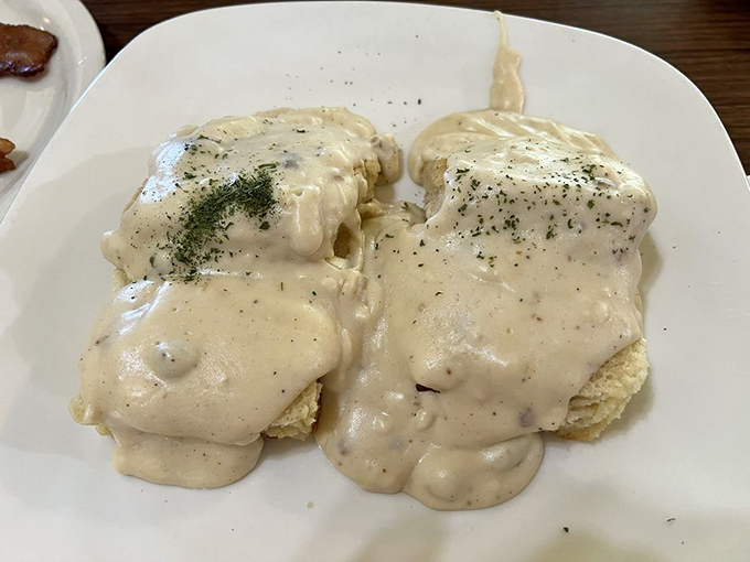 Behold the star attraction: biscuits smothered in peppery country gravy. These aren't just good—they're "text your friends immediately" good.