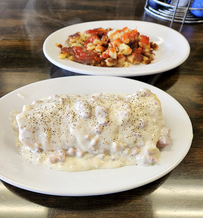 Behold the holy grail of diner breakfasts! This pepper-flecked gravy blanket doesn't just cover the biscuit—it tucks it in and reads it a bedtime story.