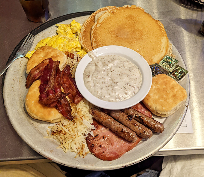 Breakfast nirvana achieved! This platter doesn't just feed you—it hugs your soul with pancakes, eggs, and gravy that would make your grandmother jealous.