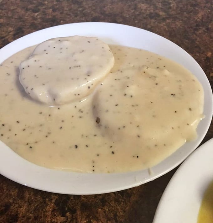 Behold, the star attraction: biscuits smothered in pepper-flecked gravy. Like a warm hug from your favorite grandma, if your grandma was a culinary genius.