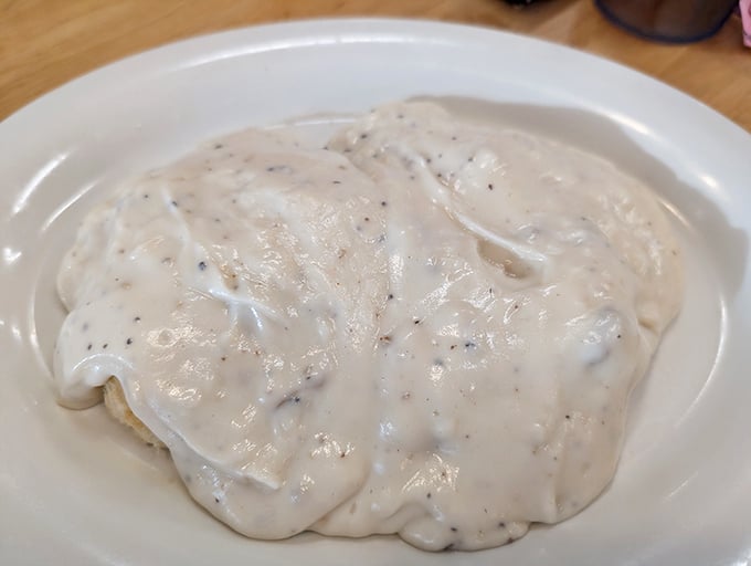 Behold the crown jewel of Southern breakfast: biscuits smothered in pepper-flecked gravy. This plate doesn't just feed your body—it hugs your soul.