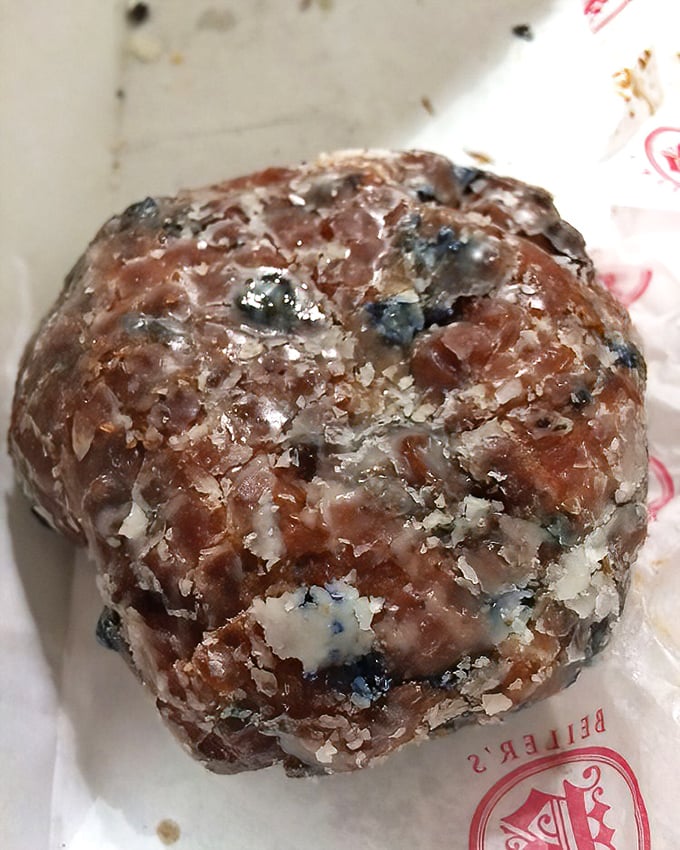 This blueberry fritter isn't just a donut – it's a commitment. Glistening with glaze and studded with berries, it's breakfast disguised as dessert.