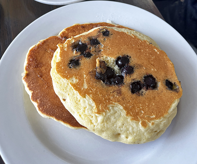 These blueberry pancakes aren't just breakfast, they're edible poetry—golden-brown canvases dotted with bursts of berry that make Monday mornings bearable again.